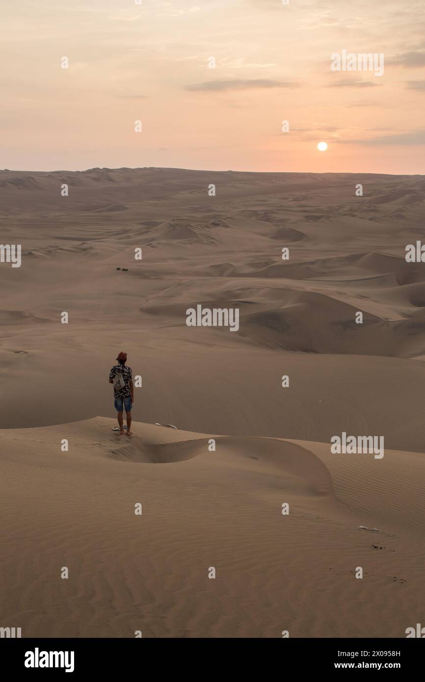Huacachina oasis, a popular tourism destination, sits amongst expansive ...