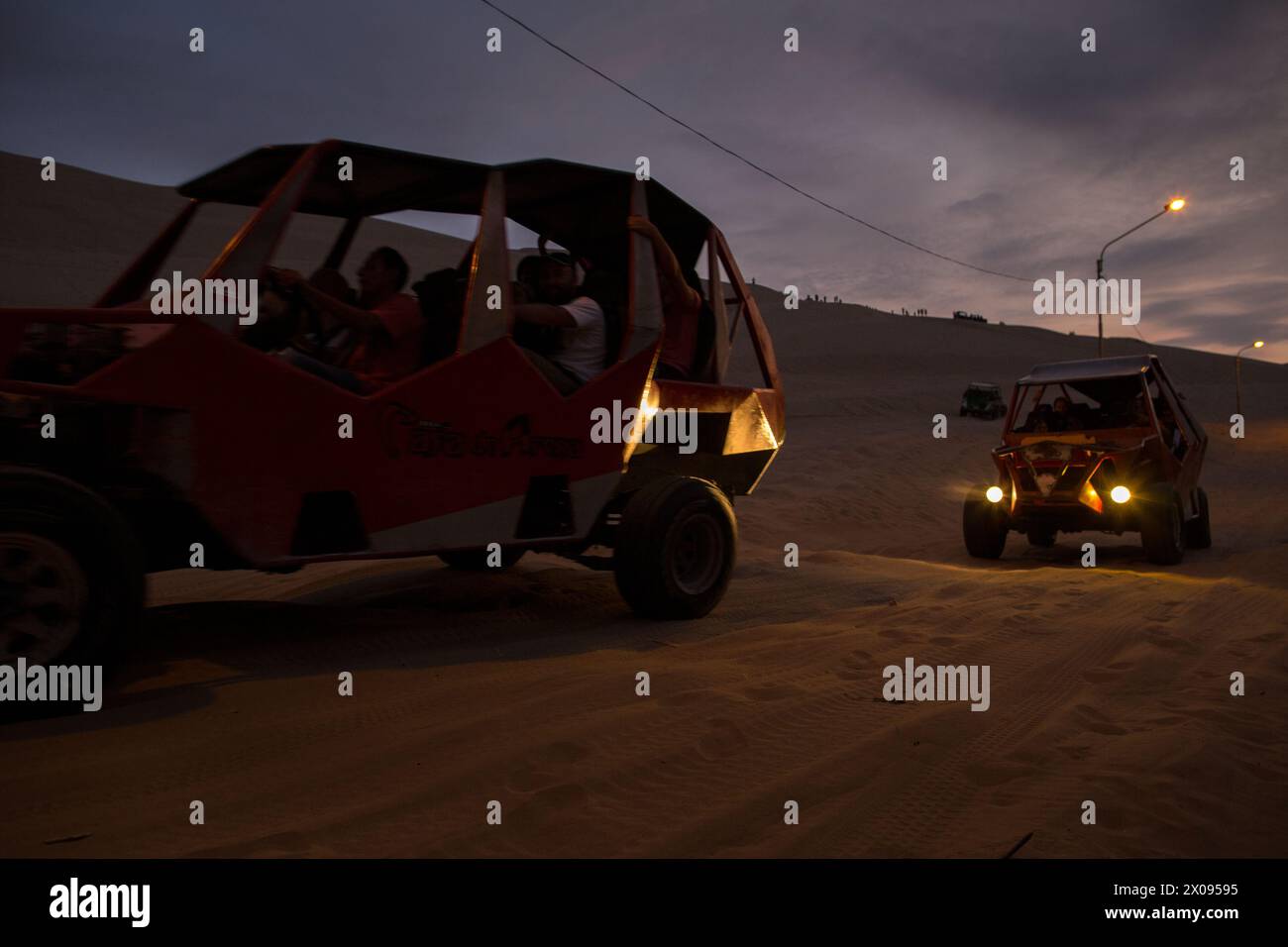 Huacachina oasis, a popular tourism destination, sits amongst expansive ...
