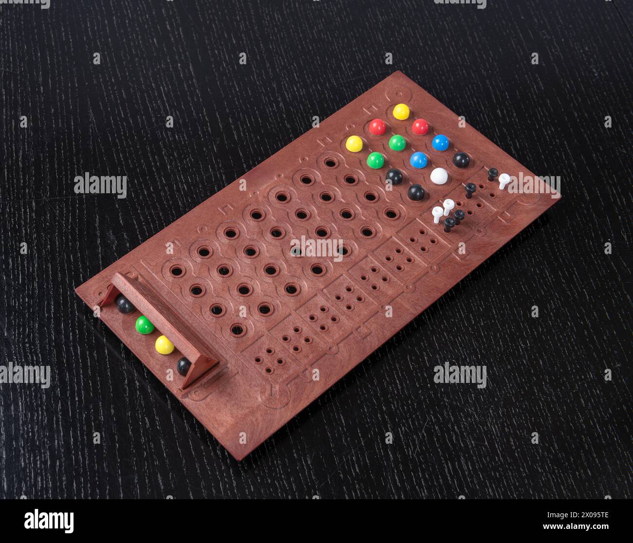 Mastermind game in progress isolated on a black background, United ...