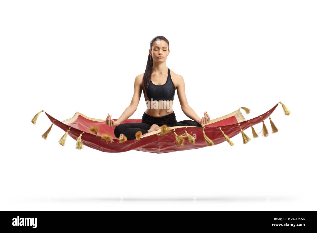 Young female in a meditation pose floating on a magic carpet isolated ...