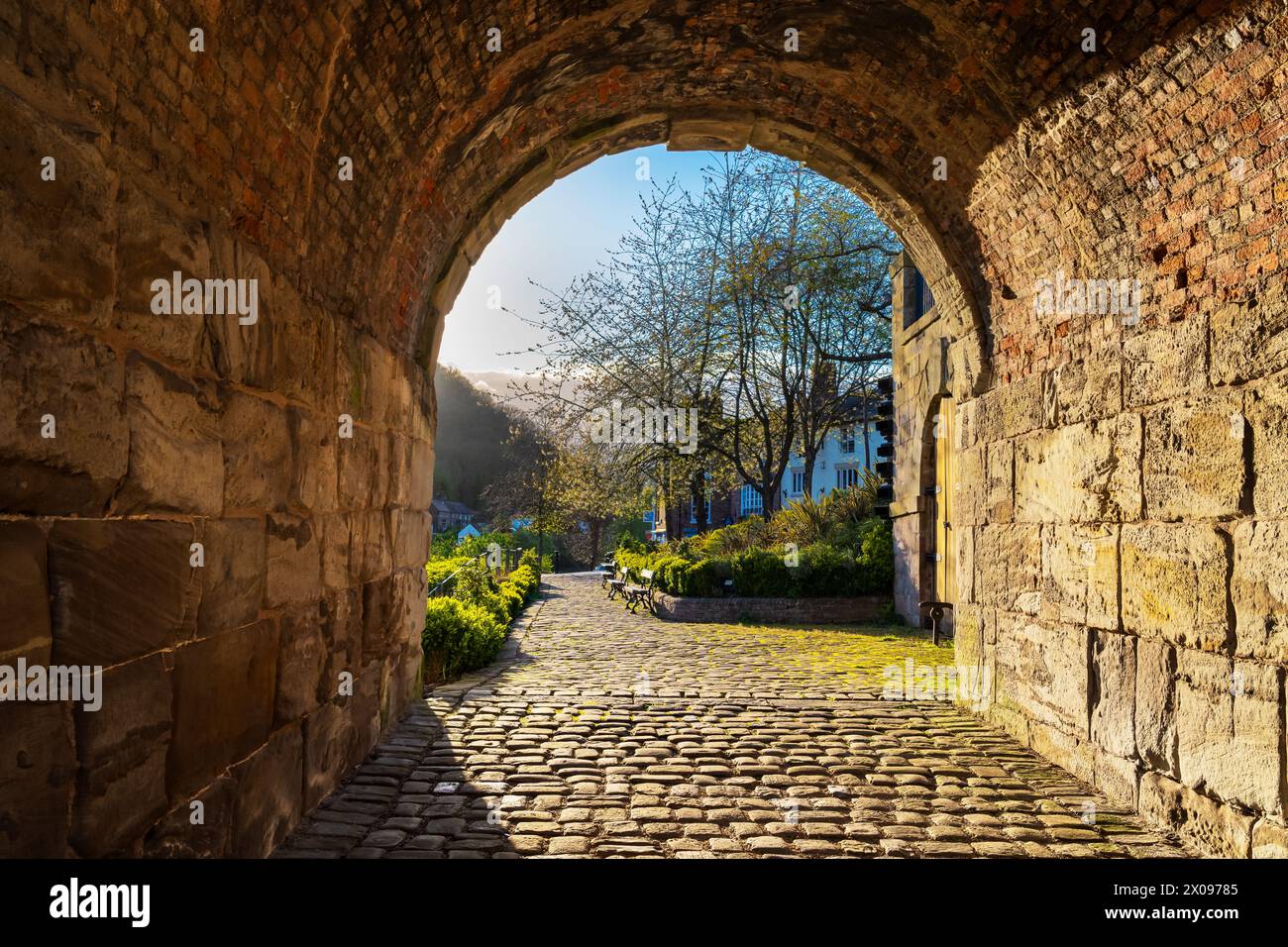 Looking out of a short tunnel underneath the Iron Bridge in Ironbridge ...