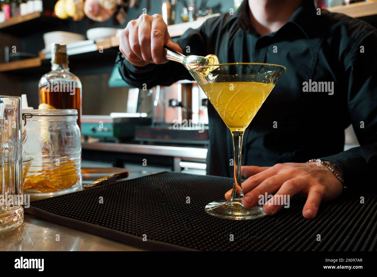 Bartender garnishing a gourmet cocktail with precision and care - skill ...