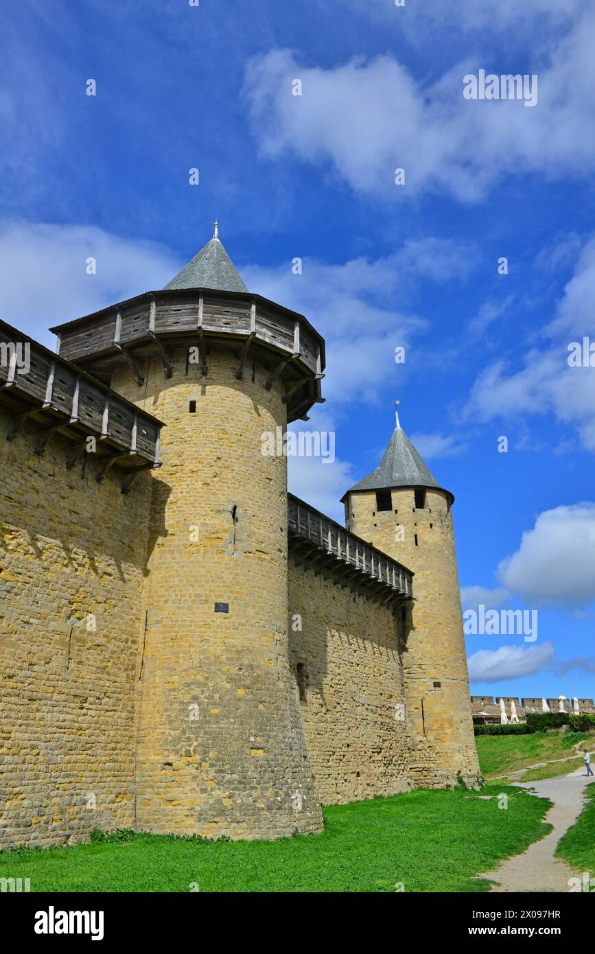 The medieval walls with hordings and towers of the fortified town of ...