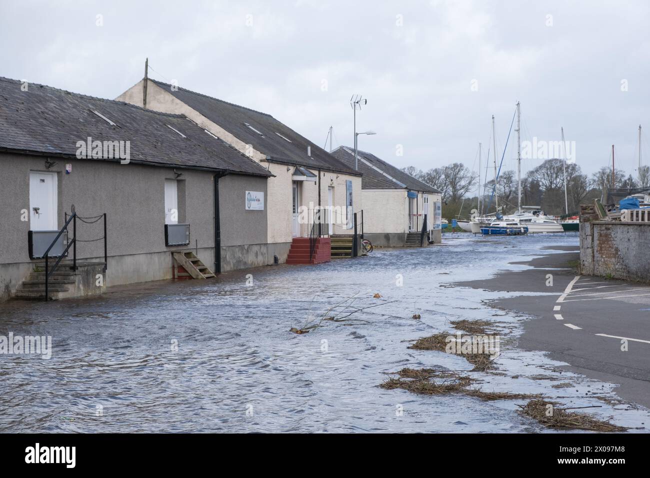 Flood water from the River Nith enters the road in the village of ...