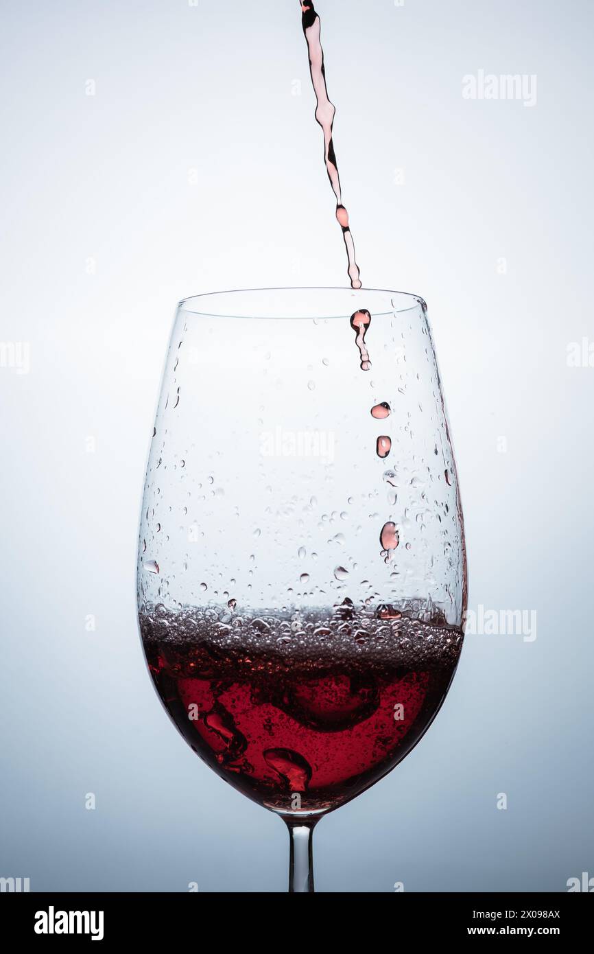 clear crystal glass with red sparkling cocktail served from above ...