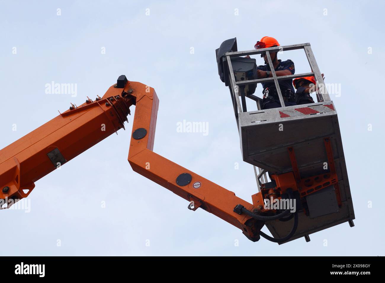 Firefighter and child in helmets in basket of retractable fire escape ...