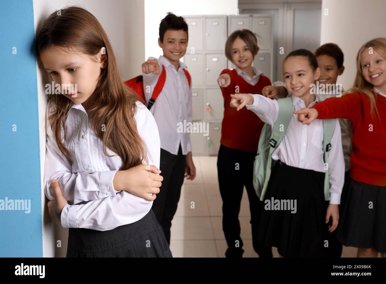 Bullied little girl at school hall Stock Photo - Alamy
