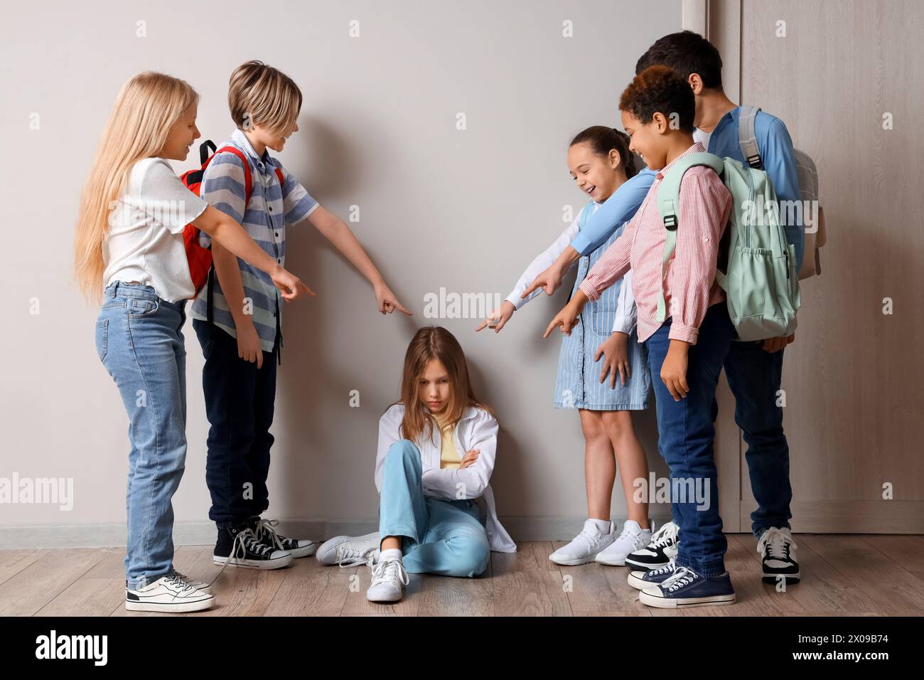 Classmates bullying little girl at school Stock Photo - Alamy