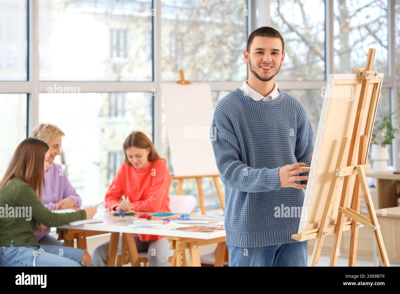 Male student painting on canvas in art school Stock Photo - Alamy