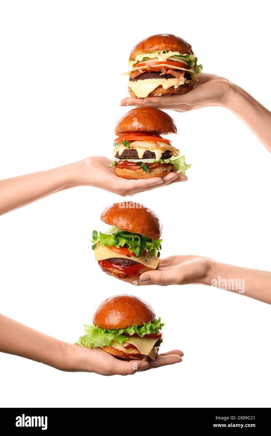 Female hands holding tasty burgers on white background Stock Photo - Alamy