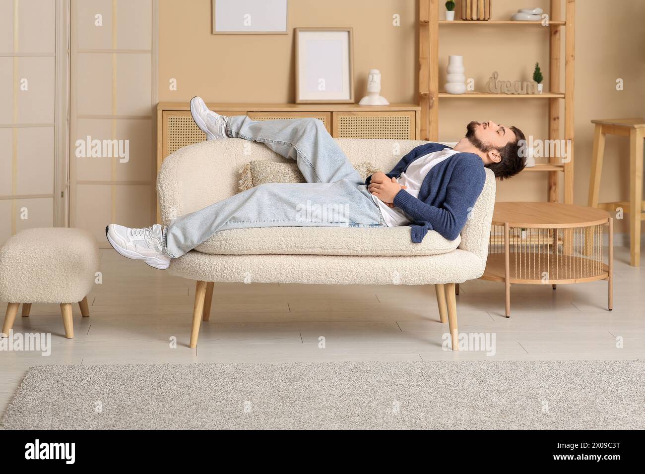 Young man sleeping on couch hi-res stock photography and images - Alamy