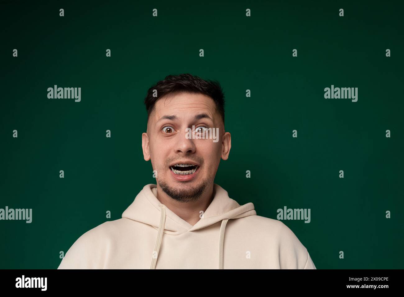 A man with a shocked expression on his face, his eyes widened and mouth ...