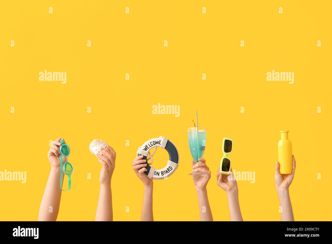 Female hands with decorative lifebuoy, cocktail, sunglasses, sunscreen ...