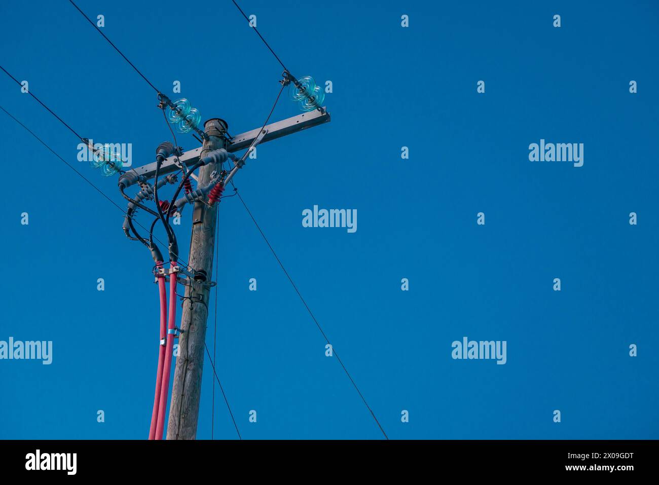 Power lines terminating into a ground cable Stock Photo - Alamy