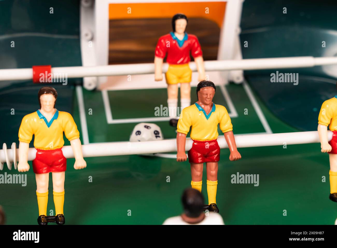 A collection of miniature toy figurines depicting soccer players in ...