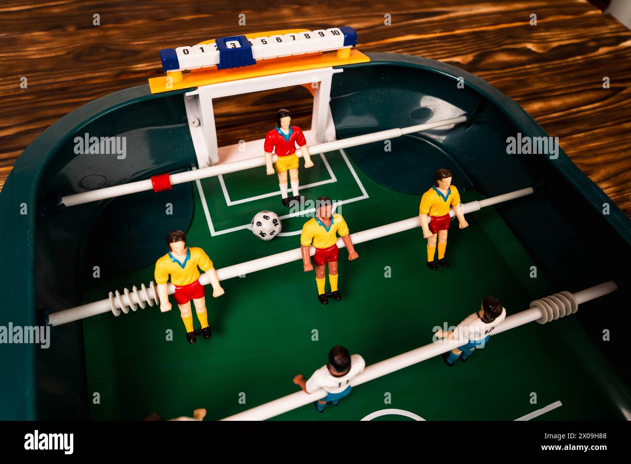 A group of individuals playing a game of soccer on a field, kicking the ...