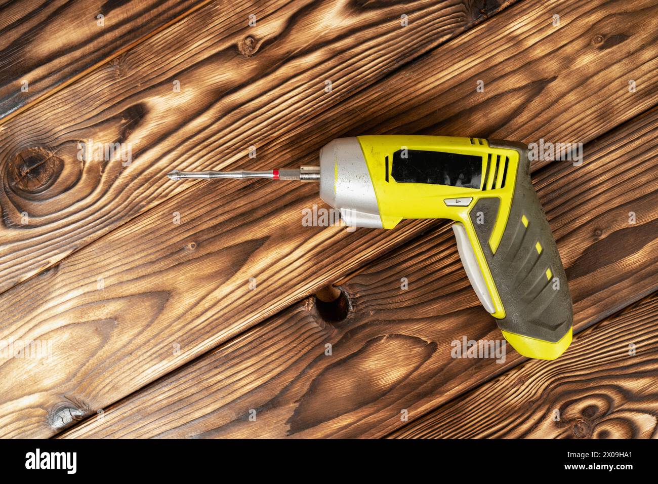 a cordless screwdriver. Cordless drill on a wooden background. DIY concept Stock Photo - Alamy