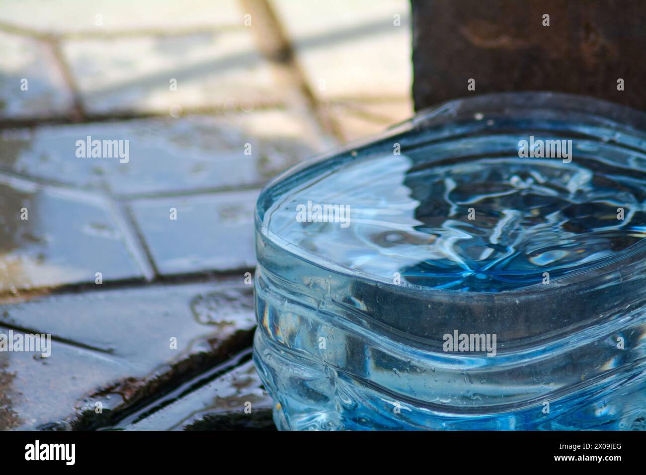 Crisp image of water in a transparent container reflecting the ...
