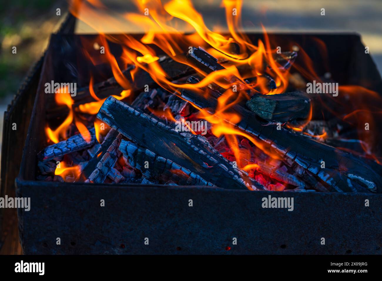 Burning wood chips to form coal. Barbecue preparation, fire before ...