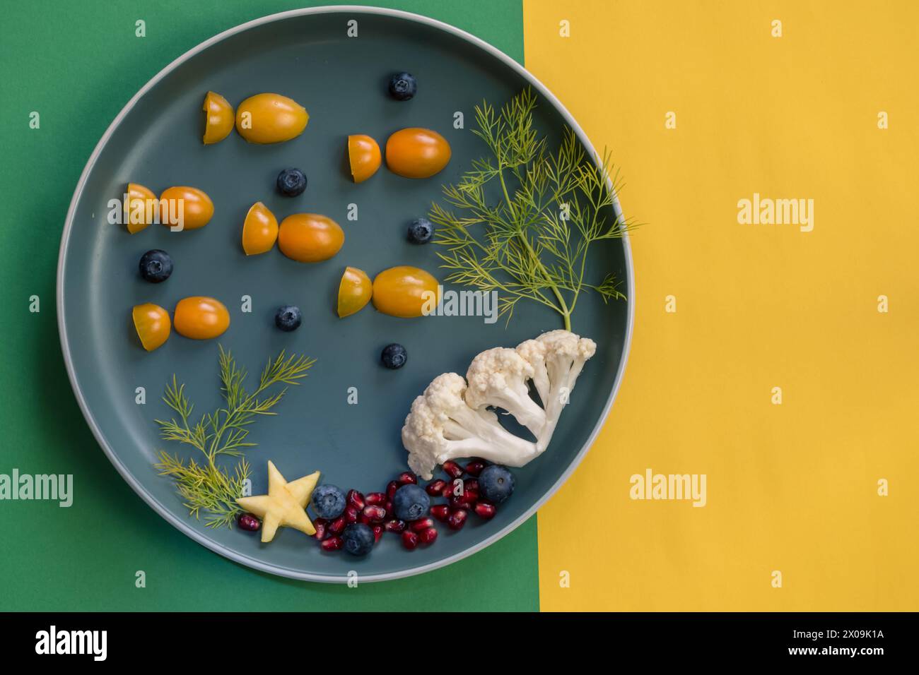 creative plate for children with fish from tomato, pomegranate and ...