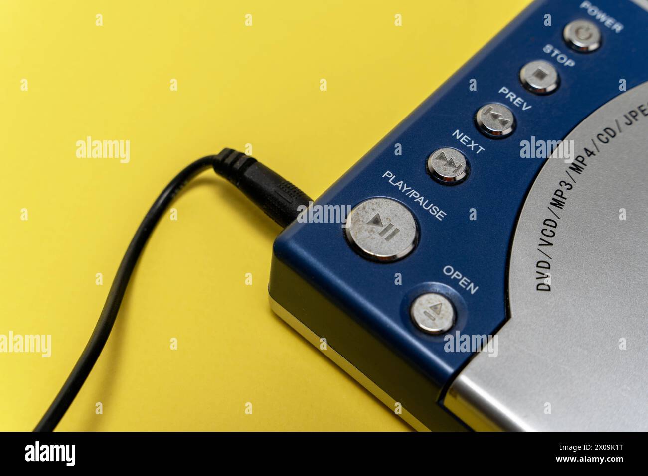 A detailed view of a CD player, DVD player placed on a yellow table ...