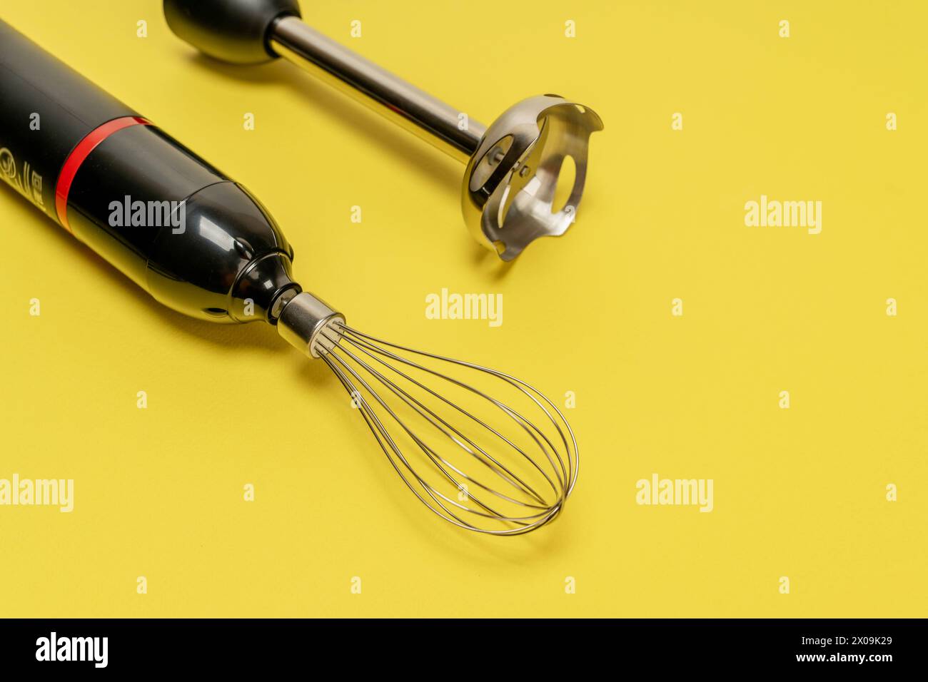 A stainless steel whisk and a whisk attachment from a kitchen appliance ...