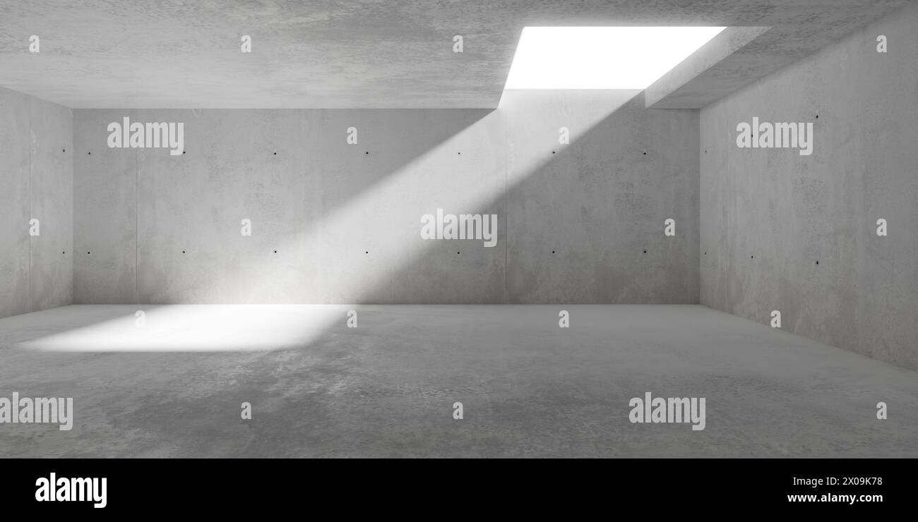 Abstract large, empty, modern concrete room with sunlight from ceiling ...