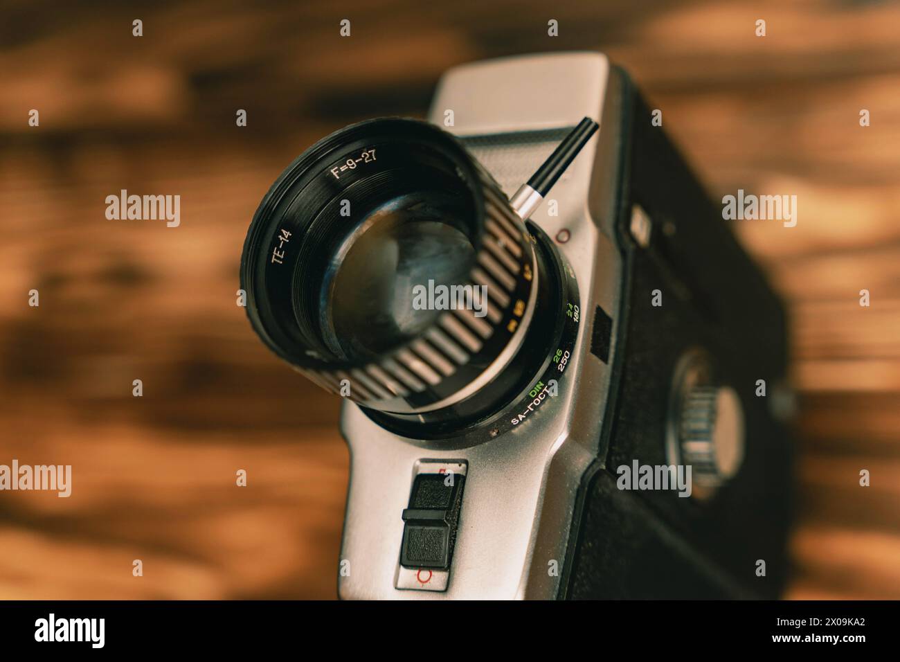 A close-up of a vintage movie camera shooting on 8 mm film from the 80s ...