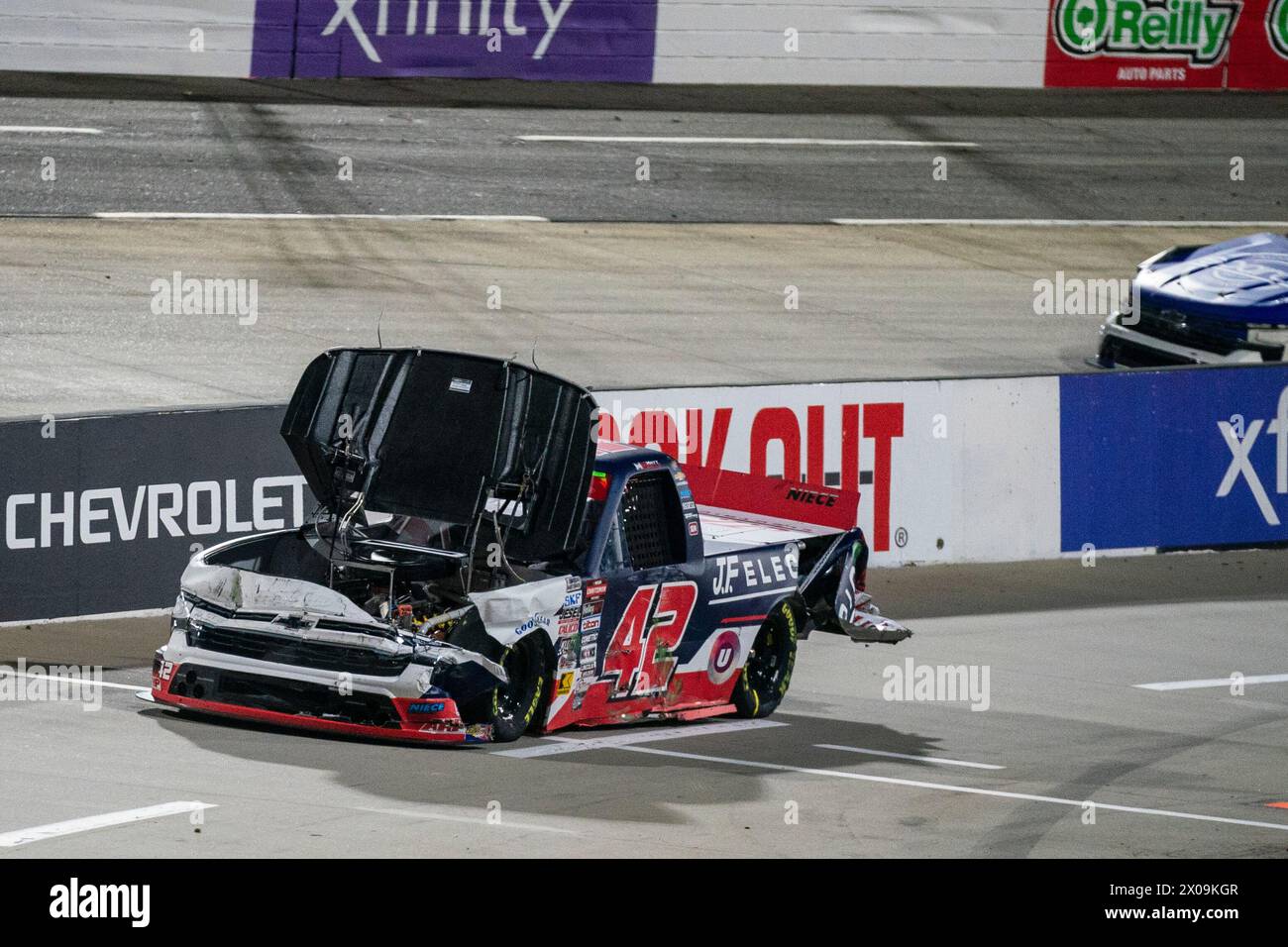 Matt Mills brings out the caution flag as he brings his truck down pit ...