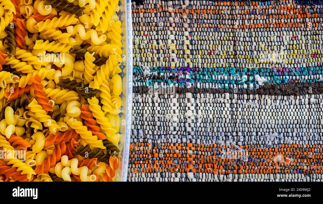 Tricolore fusilli, raw Italian pasta in plastic container, close up ...