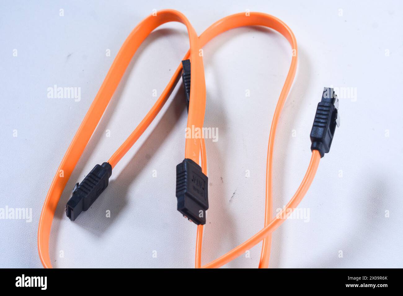 Close up orange Serial ATA(SATA) cable connected to computer ...