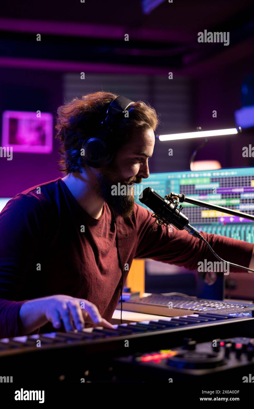 Sound engineer recording piano keys notes and singing on microphone ...
