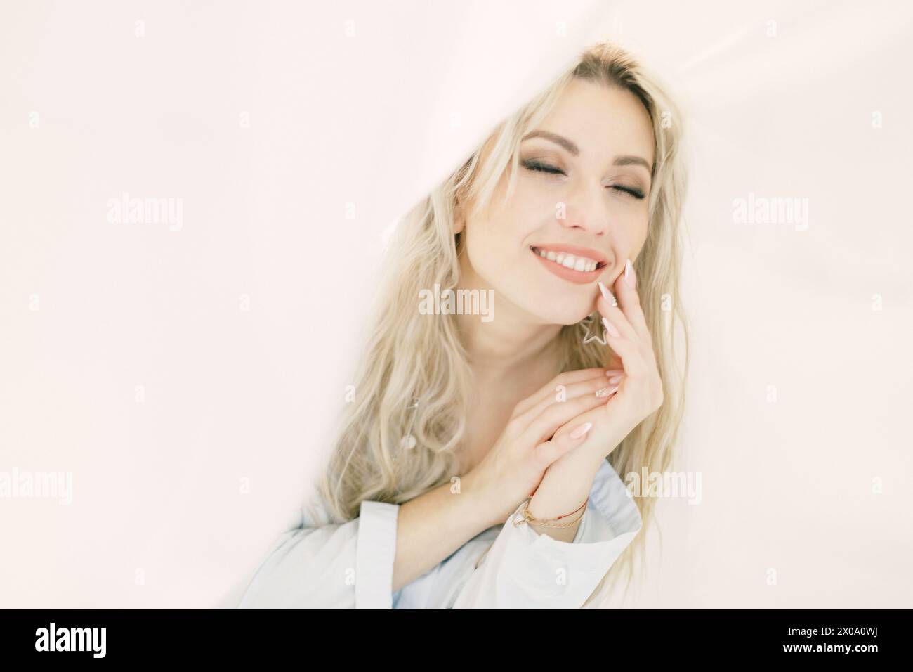 A woman with long blonde hair striking a pose for a photo Stock Photo ...