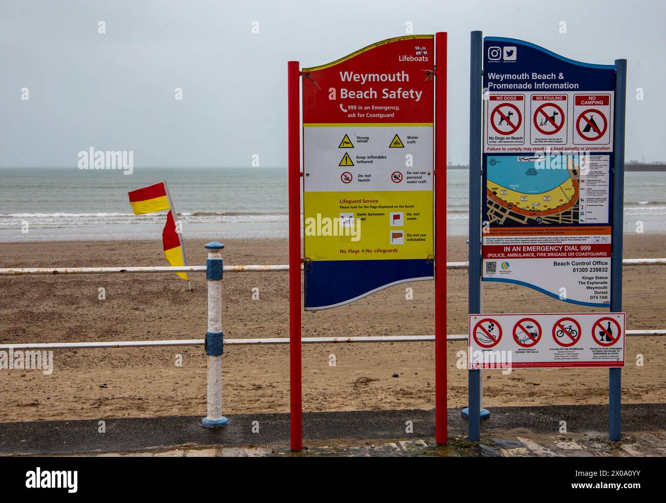 Weymouth beach safety and information board with beach lifeguard flags ...