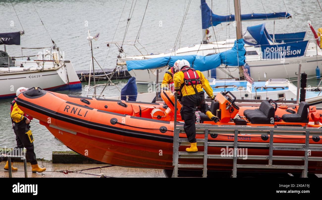 Lifeboat crew boarding the small lifeboat at Weymouth Dorset UK Stock ...