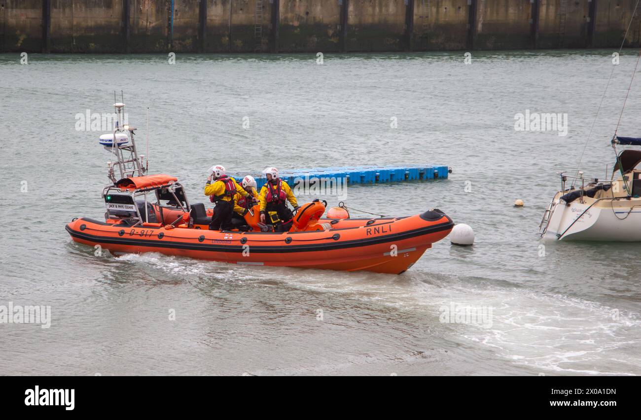Lifeboat crew setting off from Weymouth harbour Dorset Stock Photo - Alamy