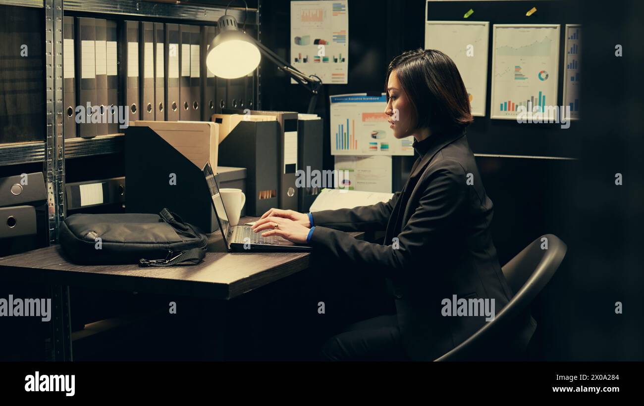 Detective uses forensic techniques to examine evidence stored in the ...