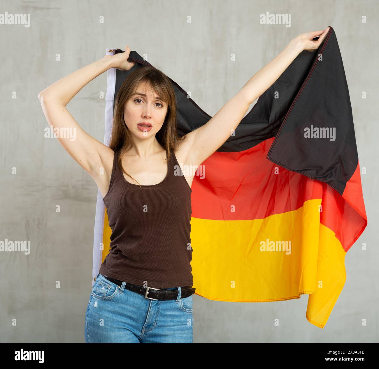 Young sad woman holding Germany flag Stock Photo - Alamy