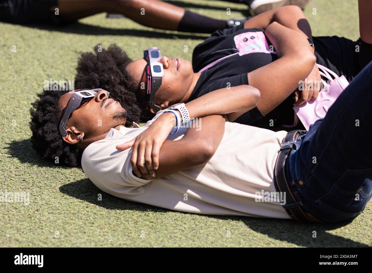 Atlanta, GA / USA - April 8, 2024: A couple wears special glasses and ...