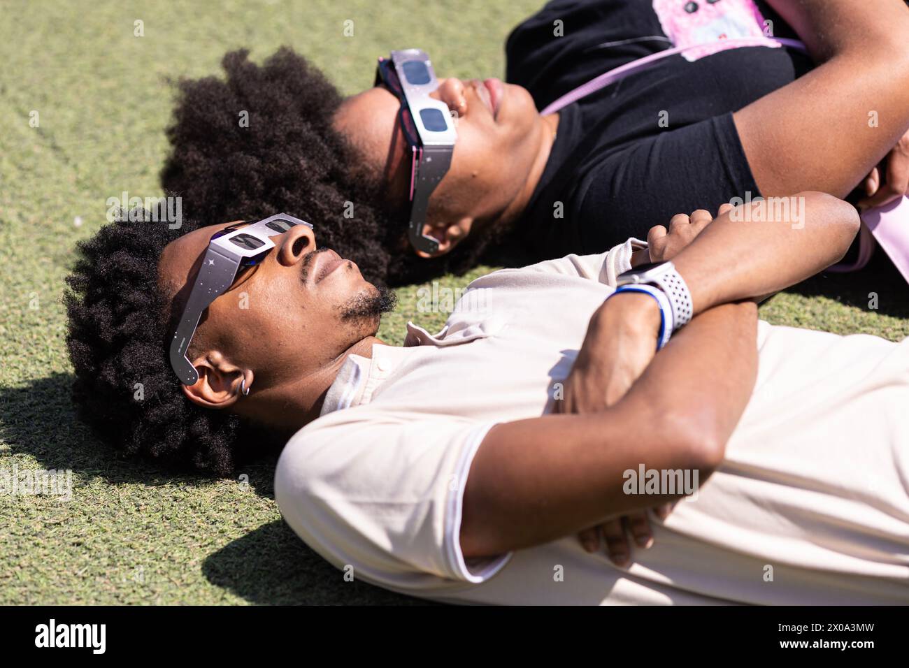 Atlanta, GA / USA - April 8, 2024: A couple wears special glasses and ...