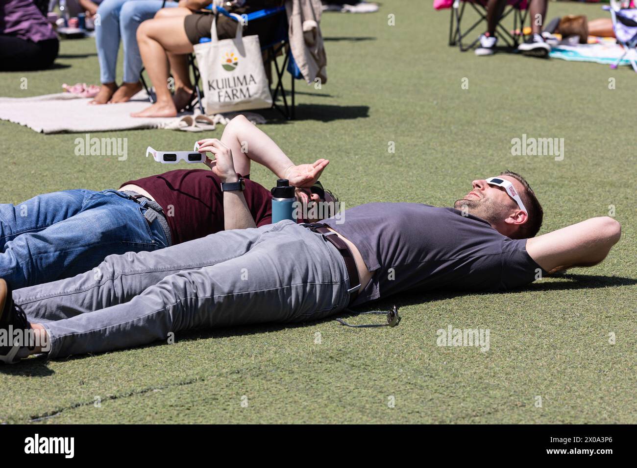 Atlanta, GA / USA - April 8, 2024: Two men lie on the ground and look ...