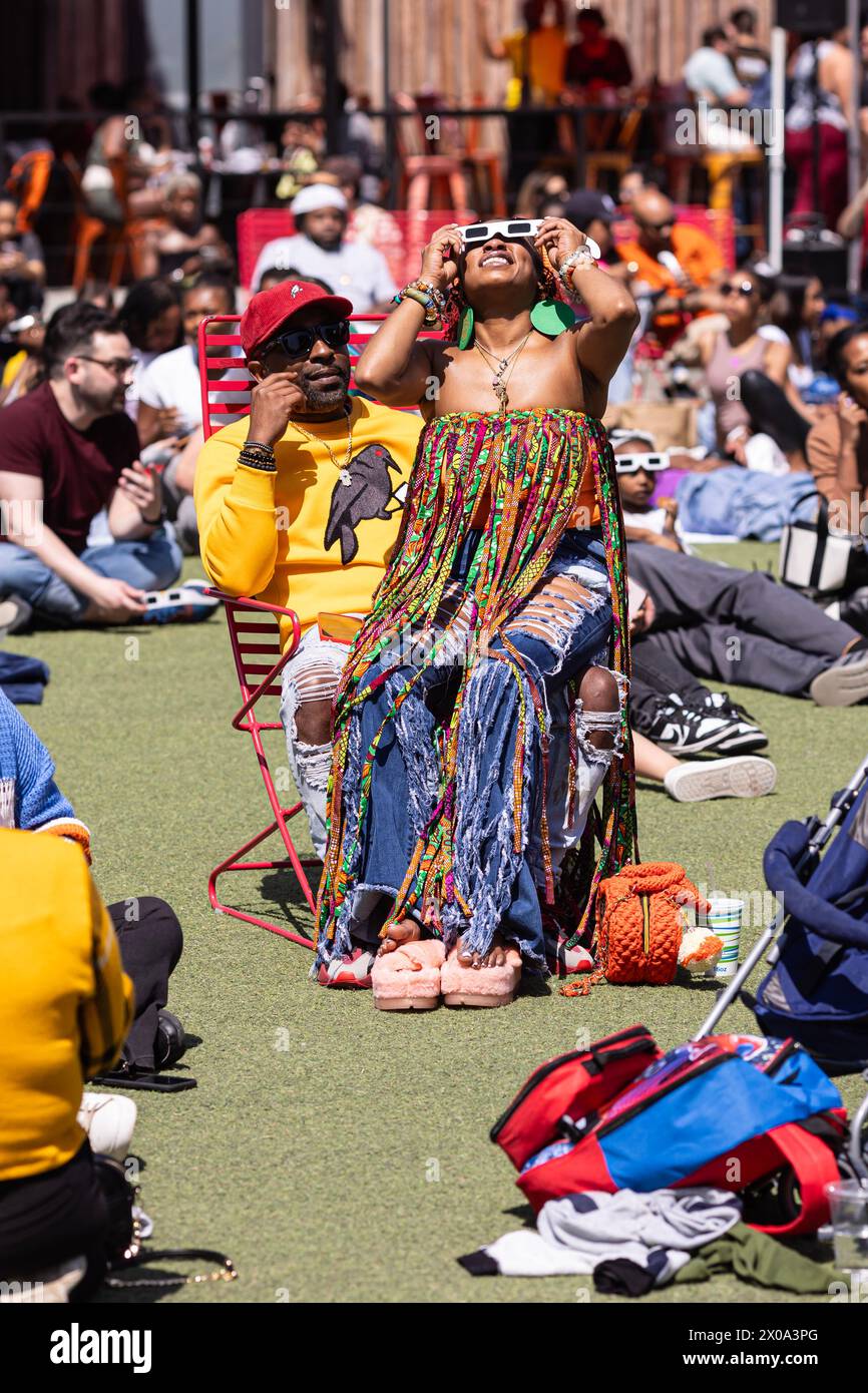 Atlanta, GA / USA - April 8, 2024: A woman wears special glasses to ...