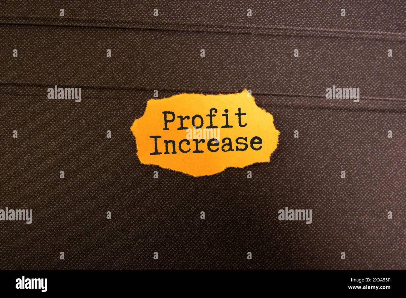 On a light background, a pen, dollars, a notebook with the text PROFIT ...