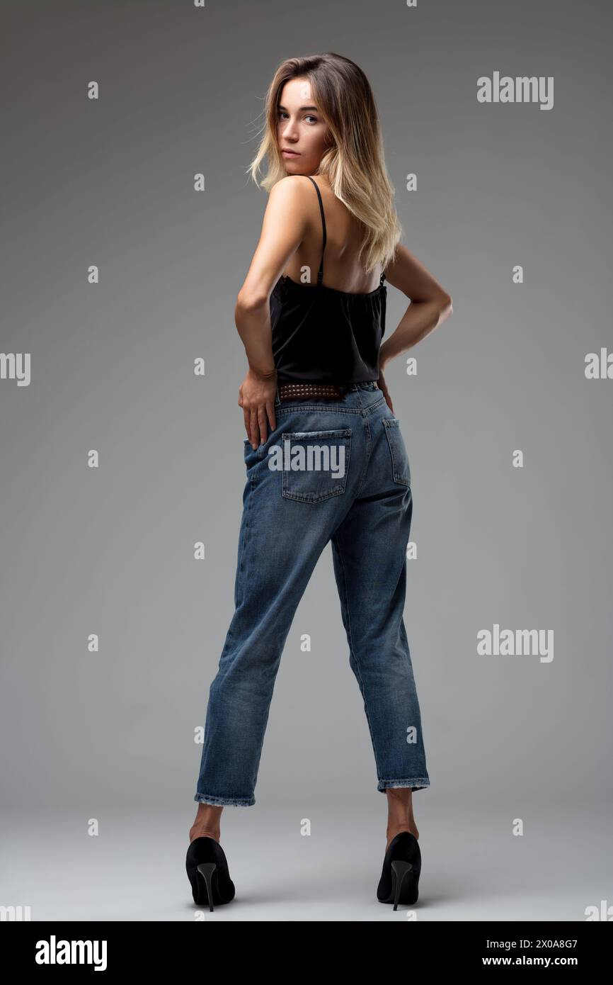 stylish portrayal showcases a woman's confident stance in denim, her ...