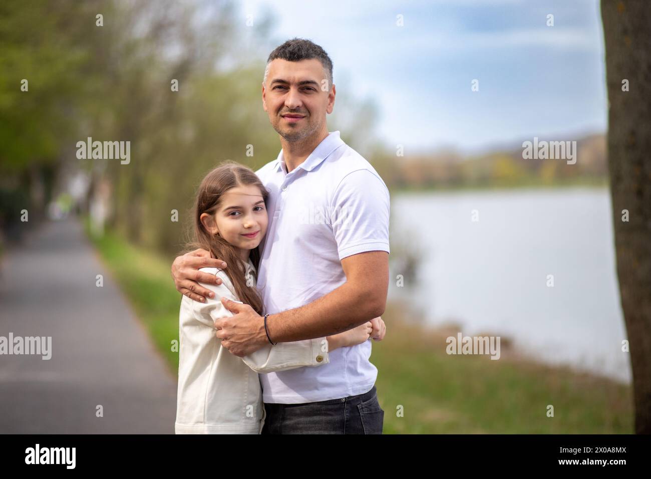 Father hugging daughter outdoors. family portrait Stock Photo - Alamy