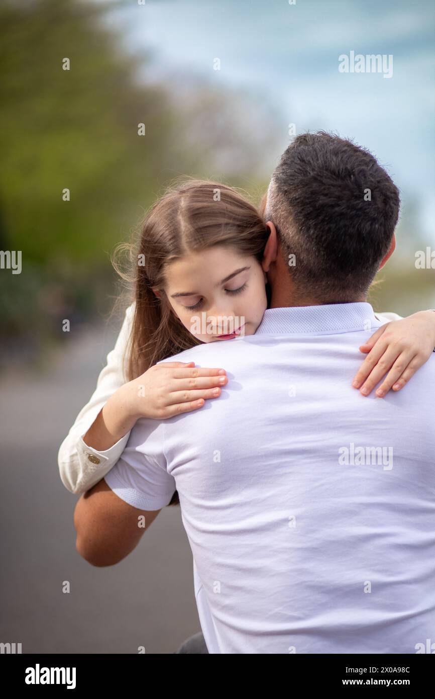 Child hugs her father, eyes closed, feeling his warmth Stock Photo - Alamy