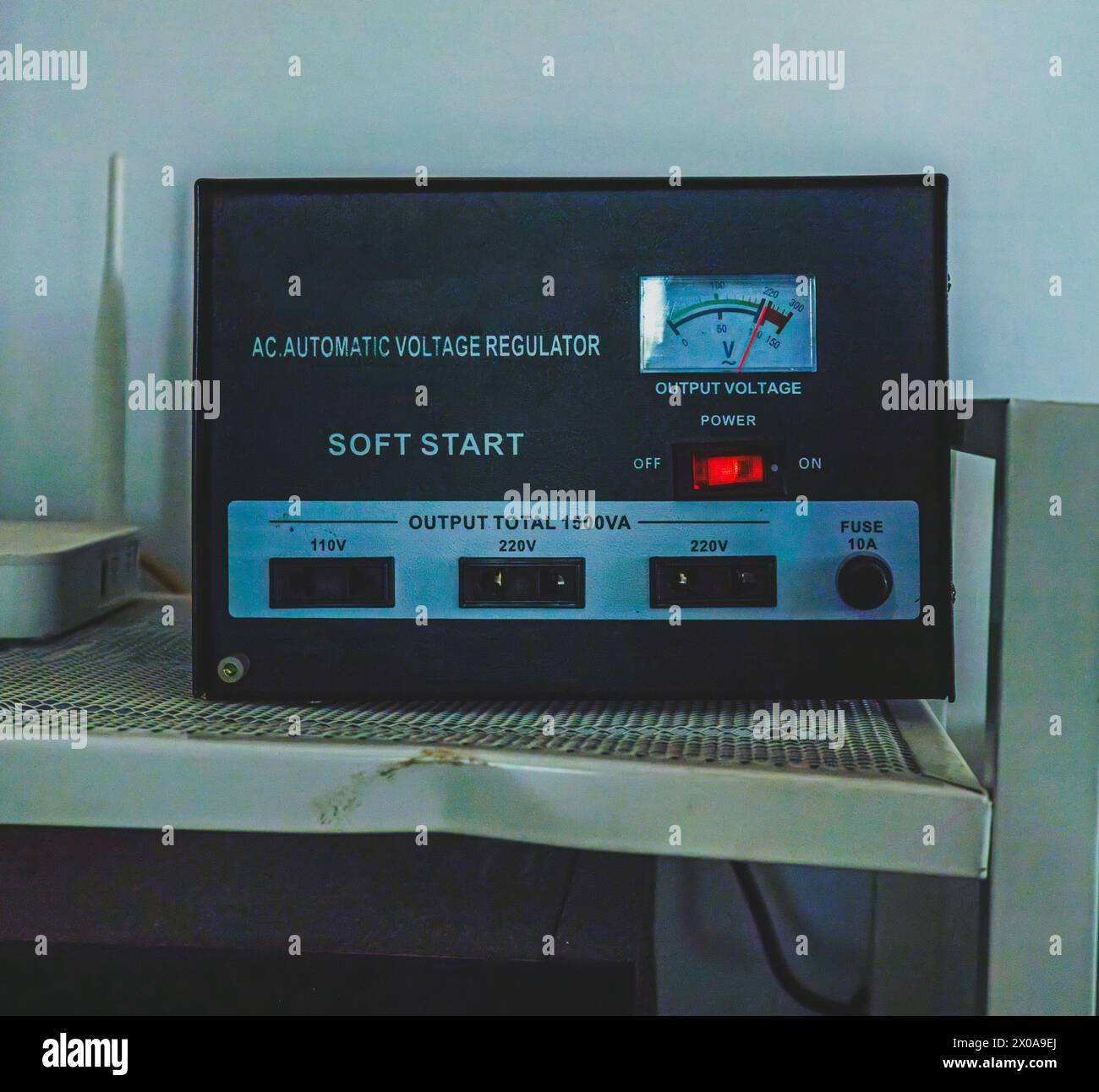 a black Automatic Voltage Regulator (AVR) with a capacity of 1500 VA ...