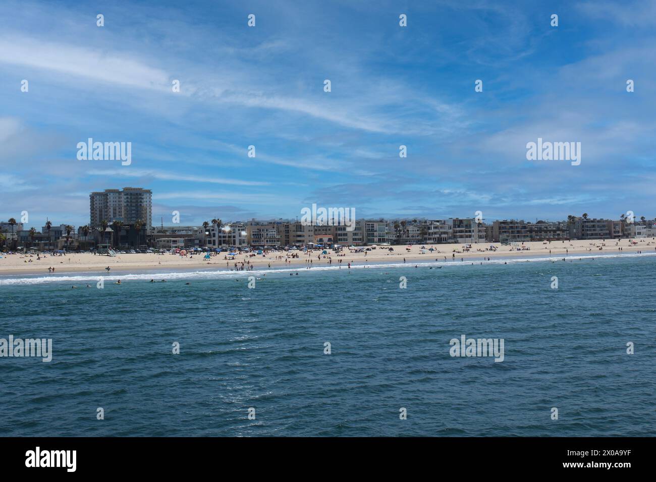 Venice Beach filled with sunbathers, sufers and people swimming as seen ...