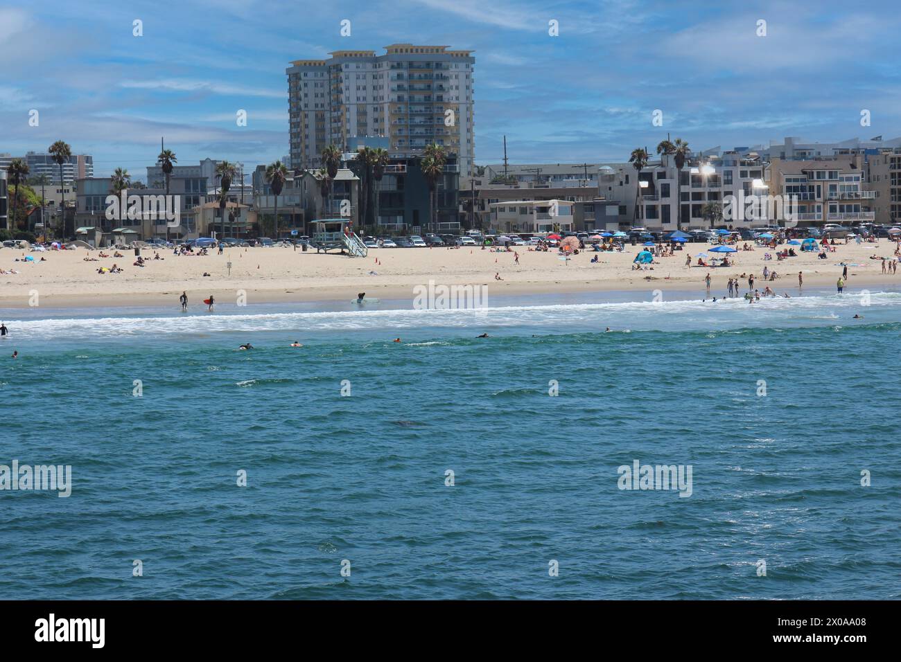 Venice Beach filled with sunbathers, sufers and people swimming as seen ...