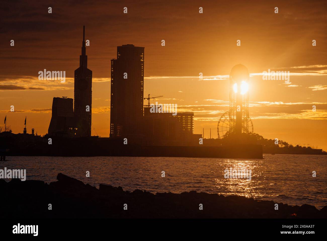 Batumi urban skyline at sunset. Shilouette of modern buildings on ...